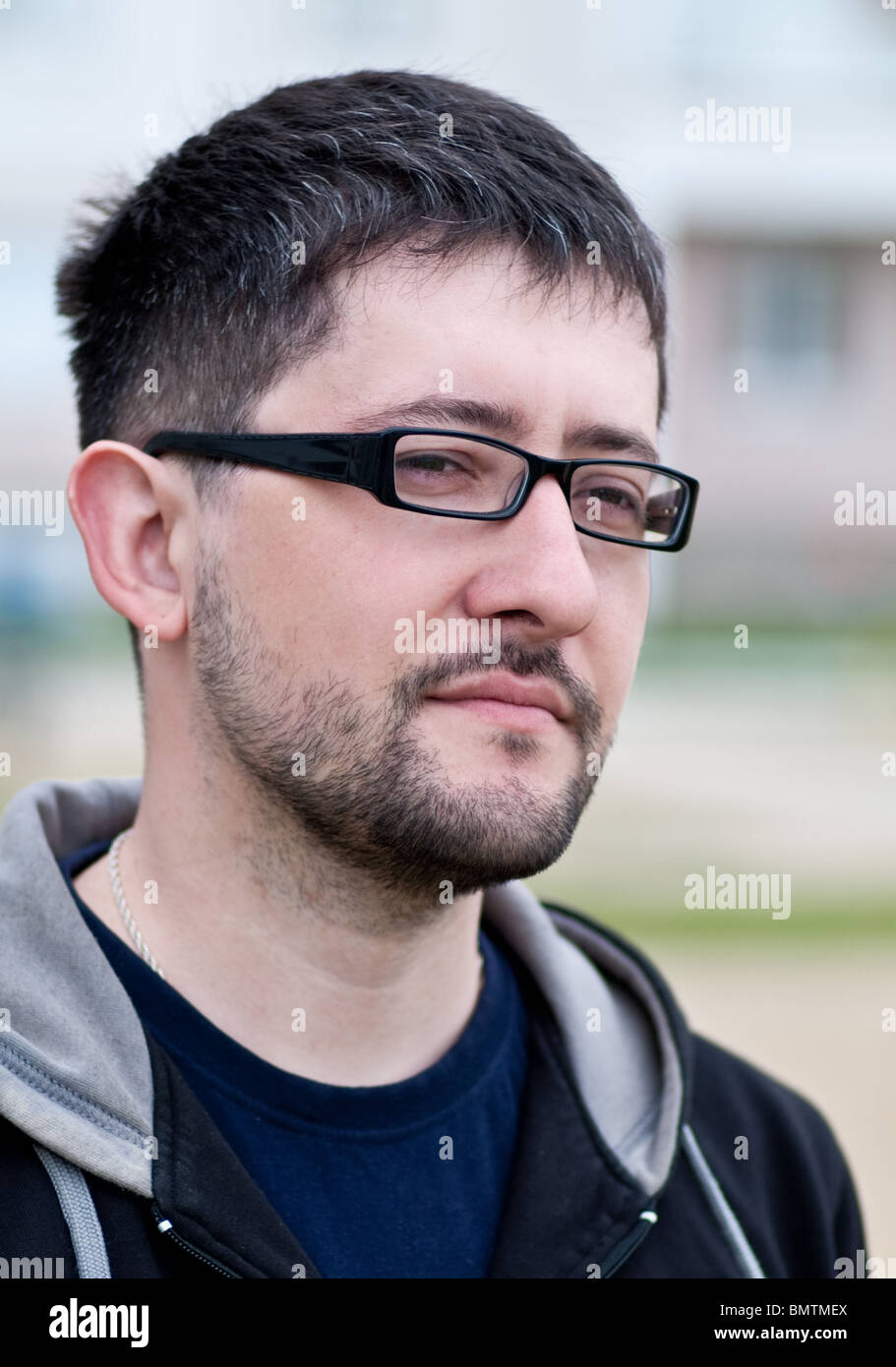 Portrait of a young male caucasian student with beard and glasses Stock ...