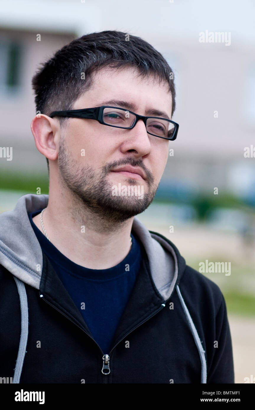 Portrait of a young male caucasian student with beard and glasses Stock ...