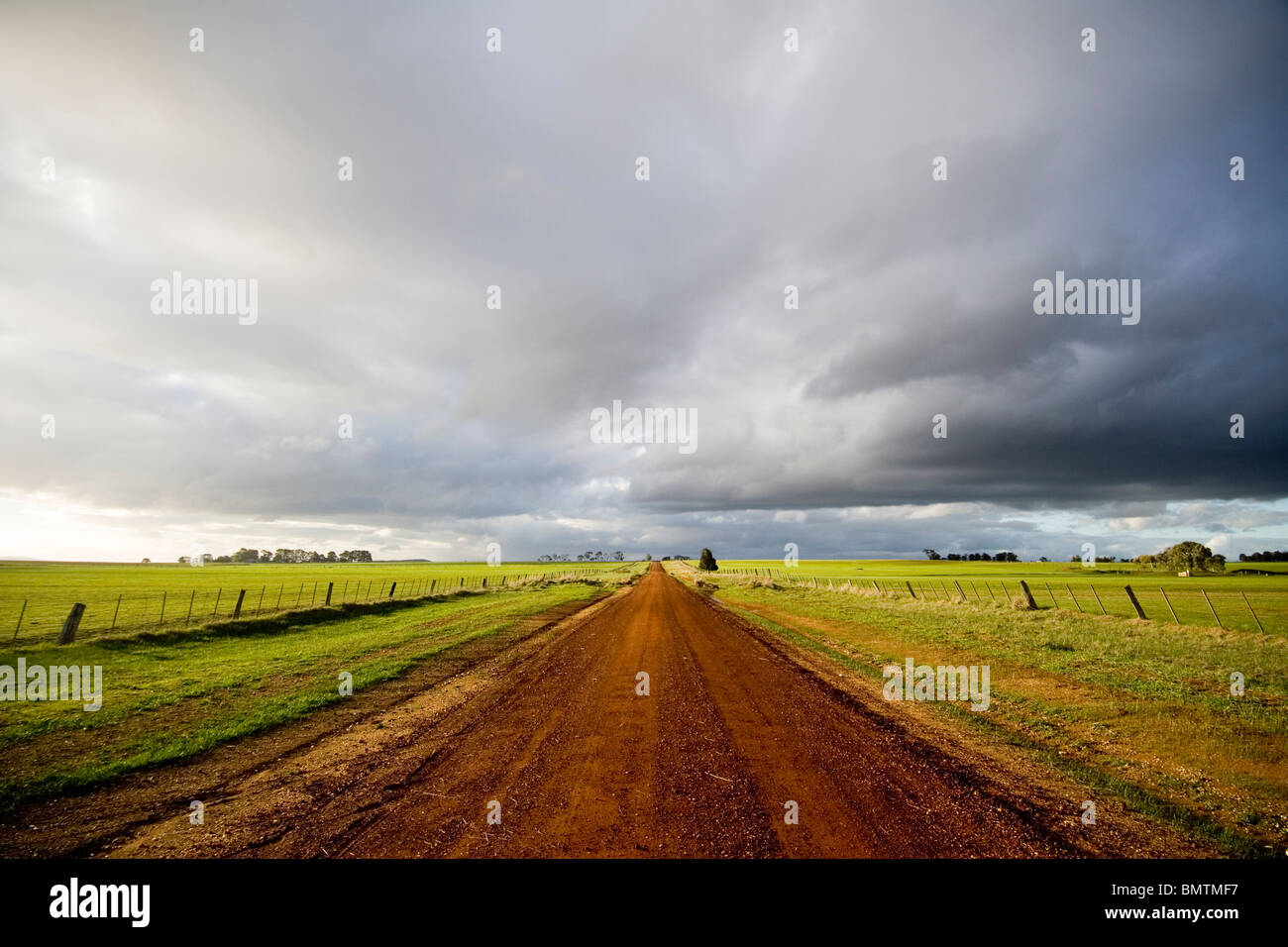 Beautiful light appears amidst winter storms on a deserted country road ...