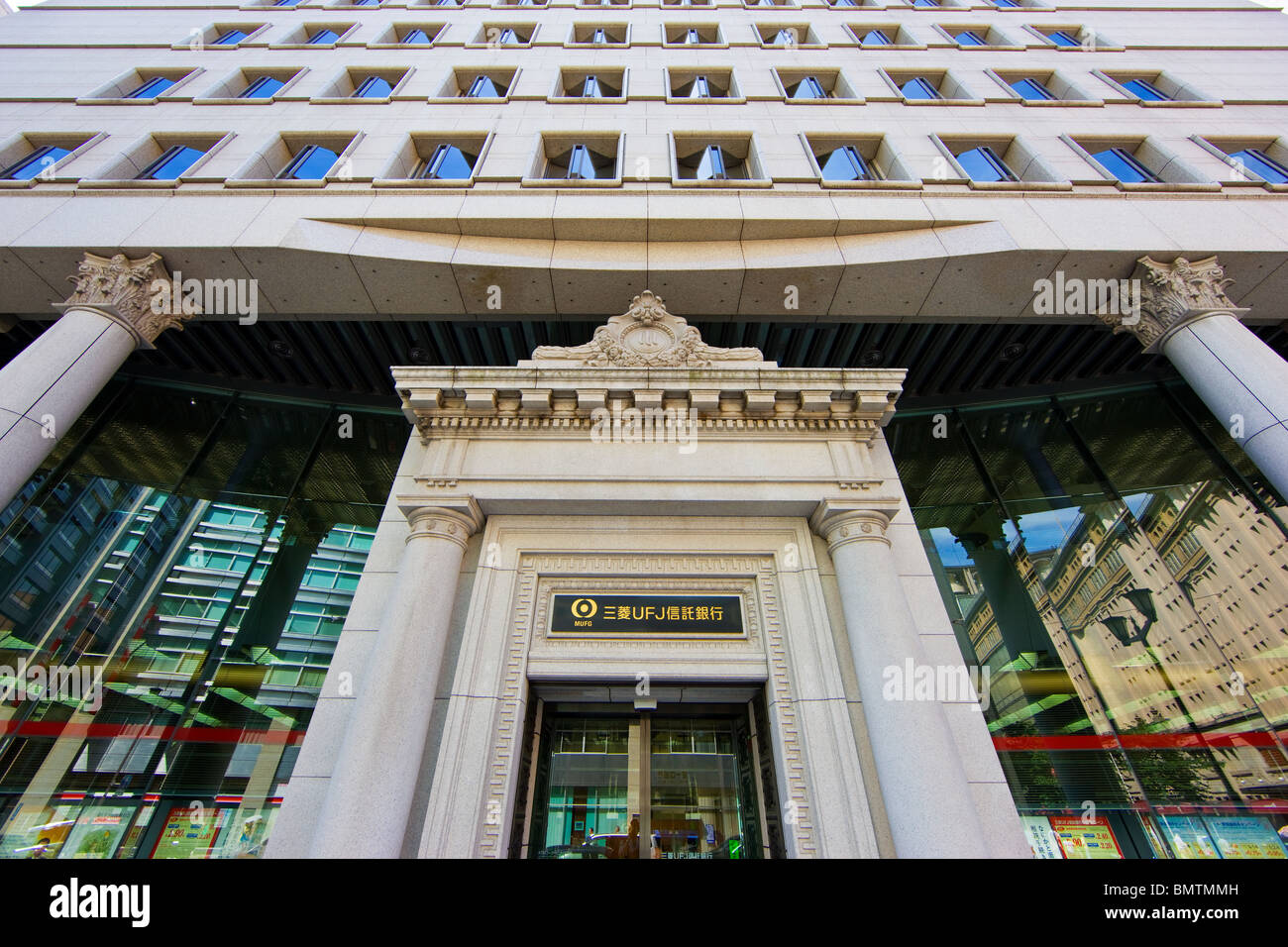 The temple-like facade of the Bank of Tokyo-Mitsubishi UFJ reflects the ...