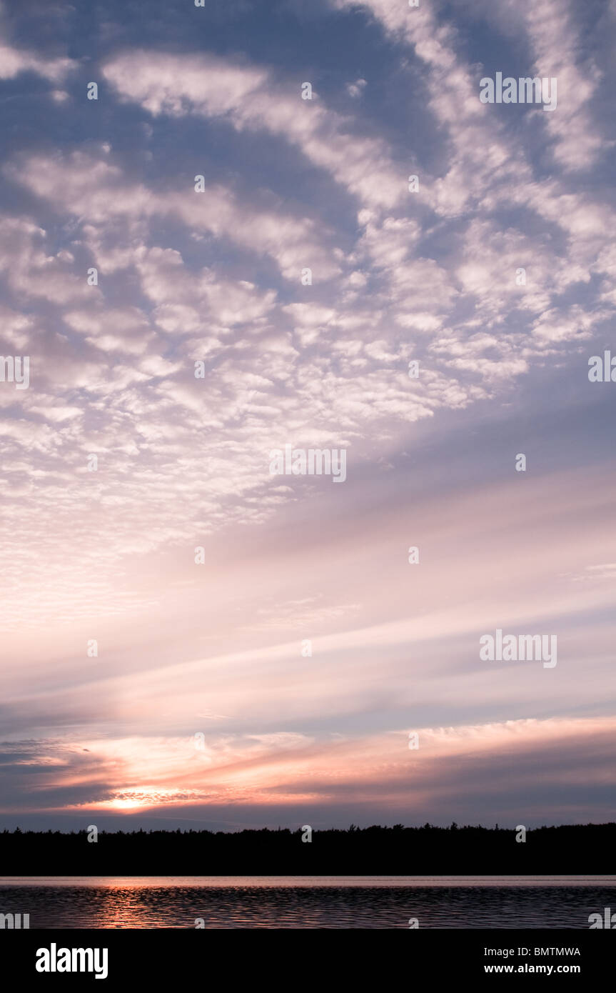 Dramatic purple sunset over water Stock Photo - Alamy