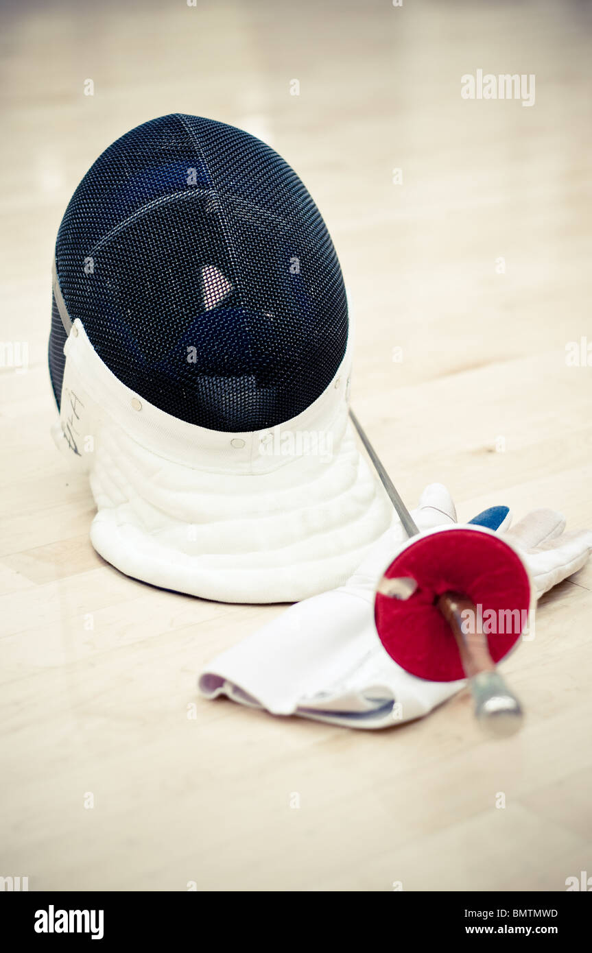 Fencing helmet outfit and sword Stock Photo - Alamy