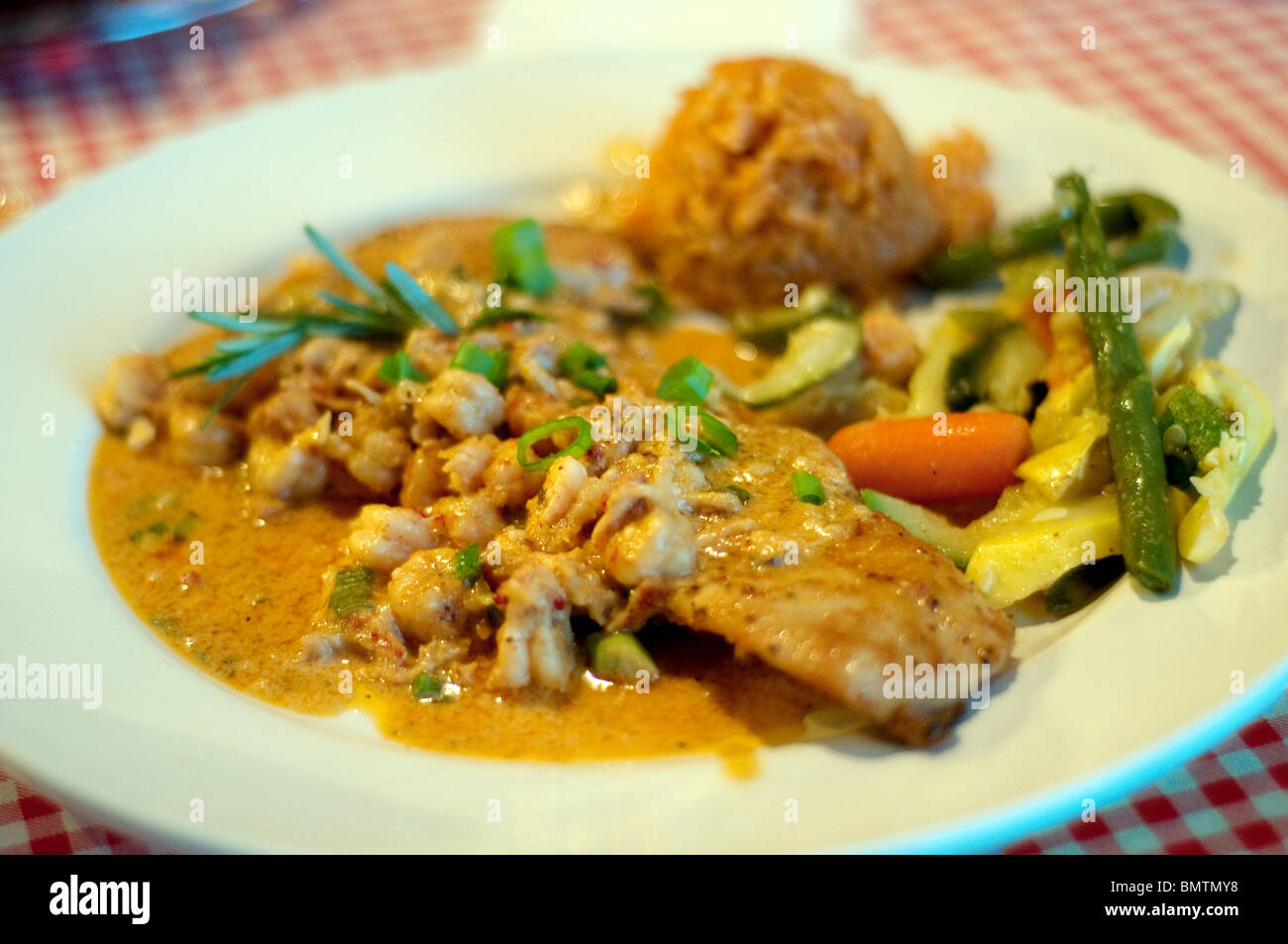 A plate of fresh pan fried Gulf snapper and long grain rice smothered ...