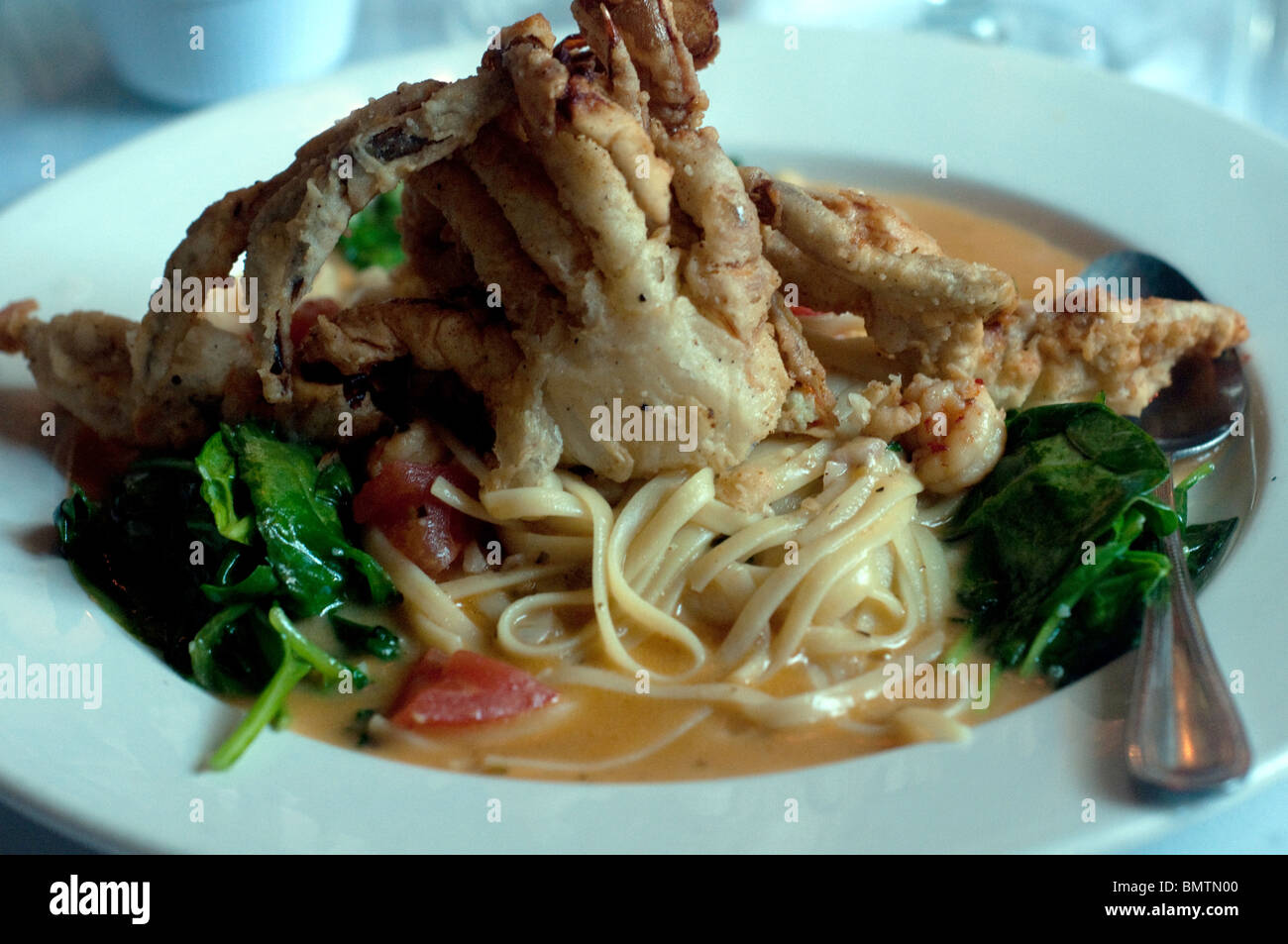 A dish of soft-shell crab linguine with crawfish sauce served at a ...