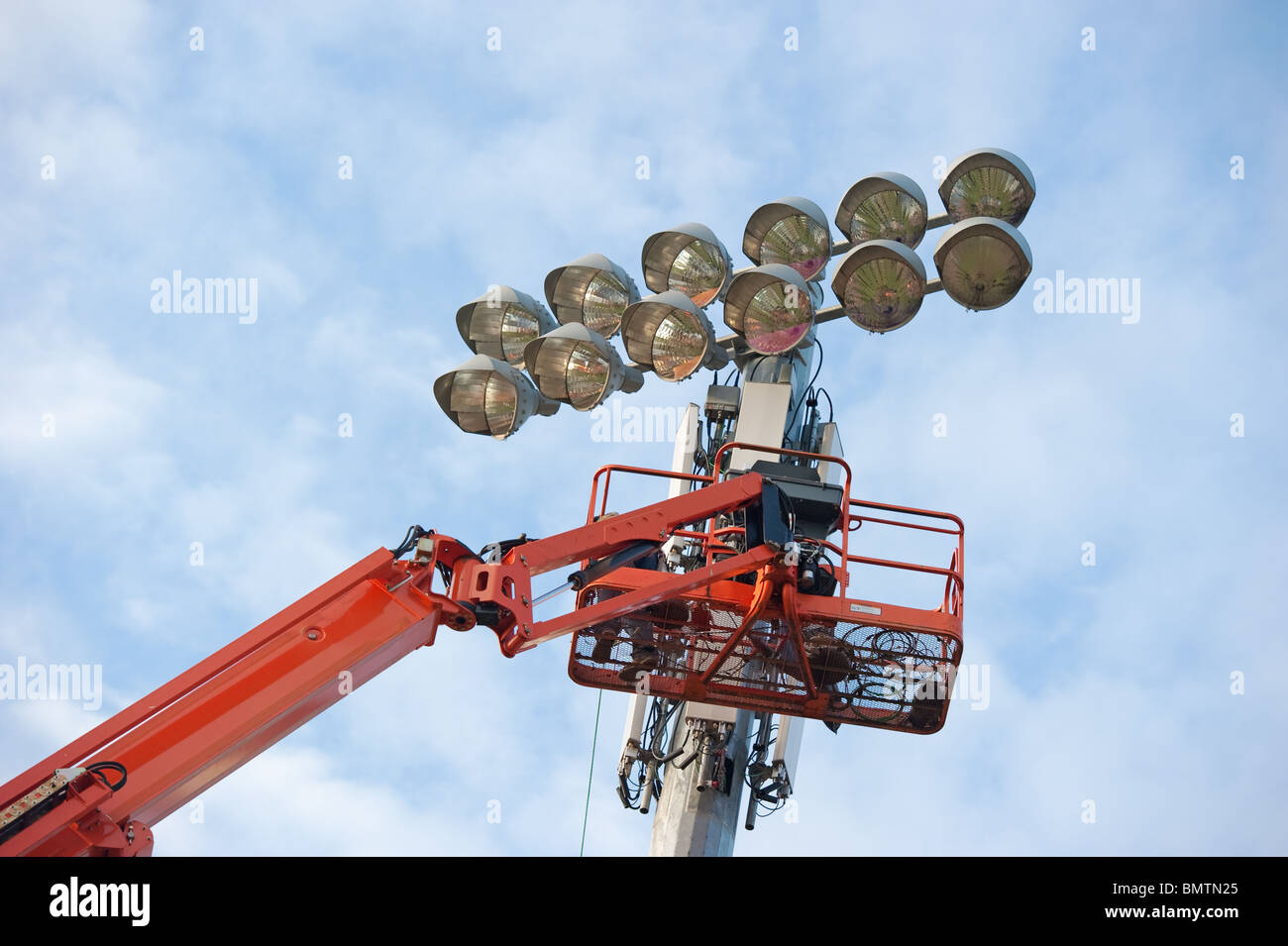 fixing a stadium light with a super boom Stock Photo - Alamy
