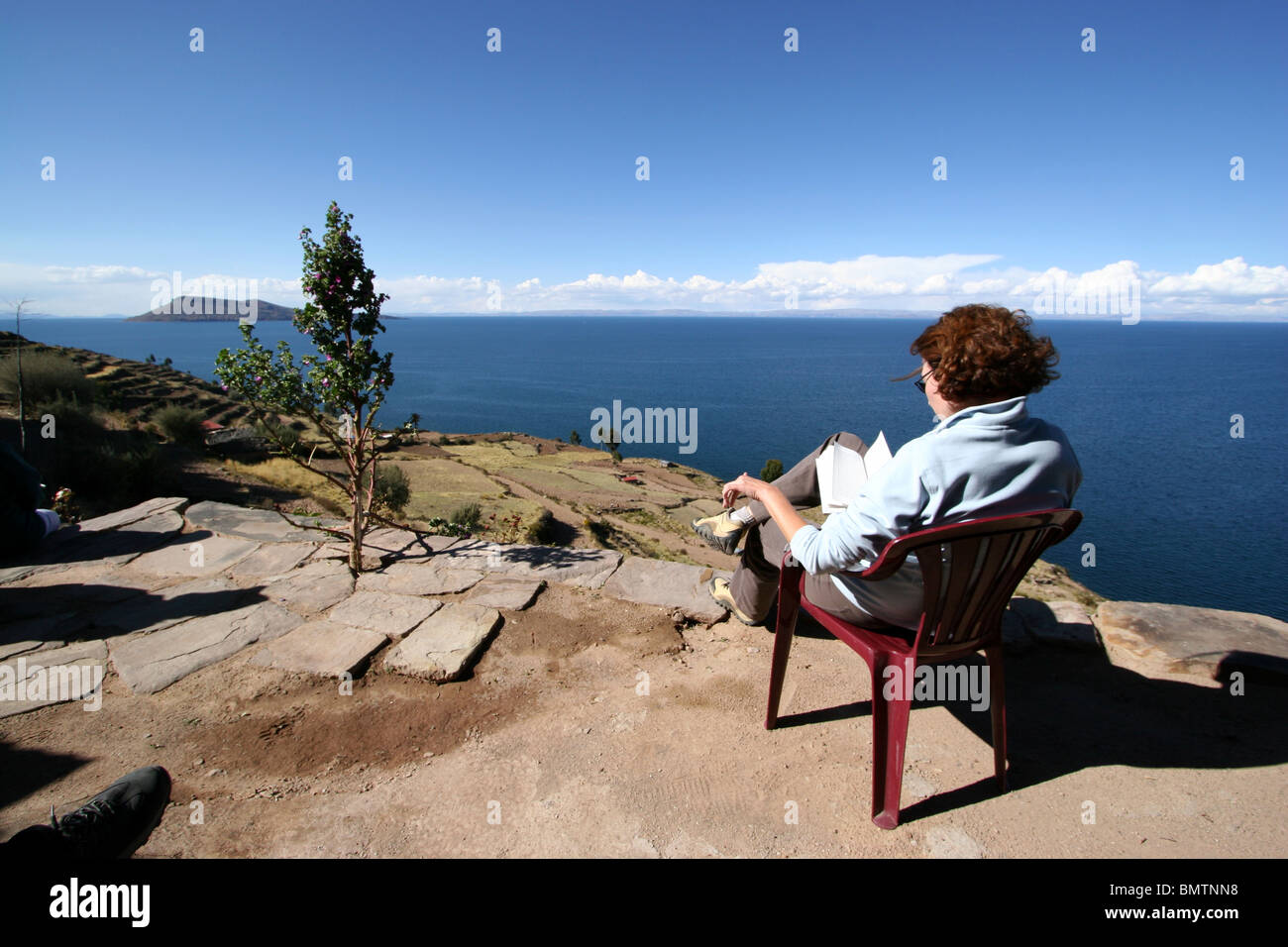 Woman reading a book, Taquile Island, Lake Titicaca, Peru Stock Photo ...