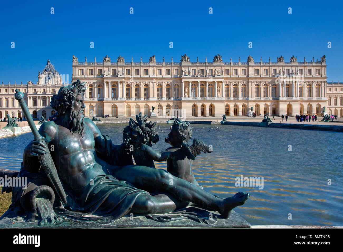 Bronze Sculpture at Fountain's Edge in Garden at Chateau de Versailles ...
