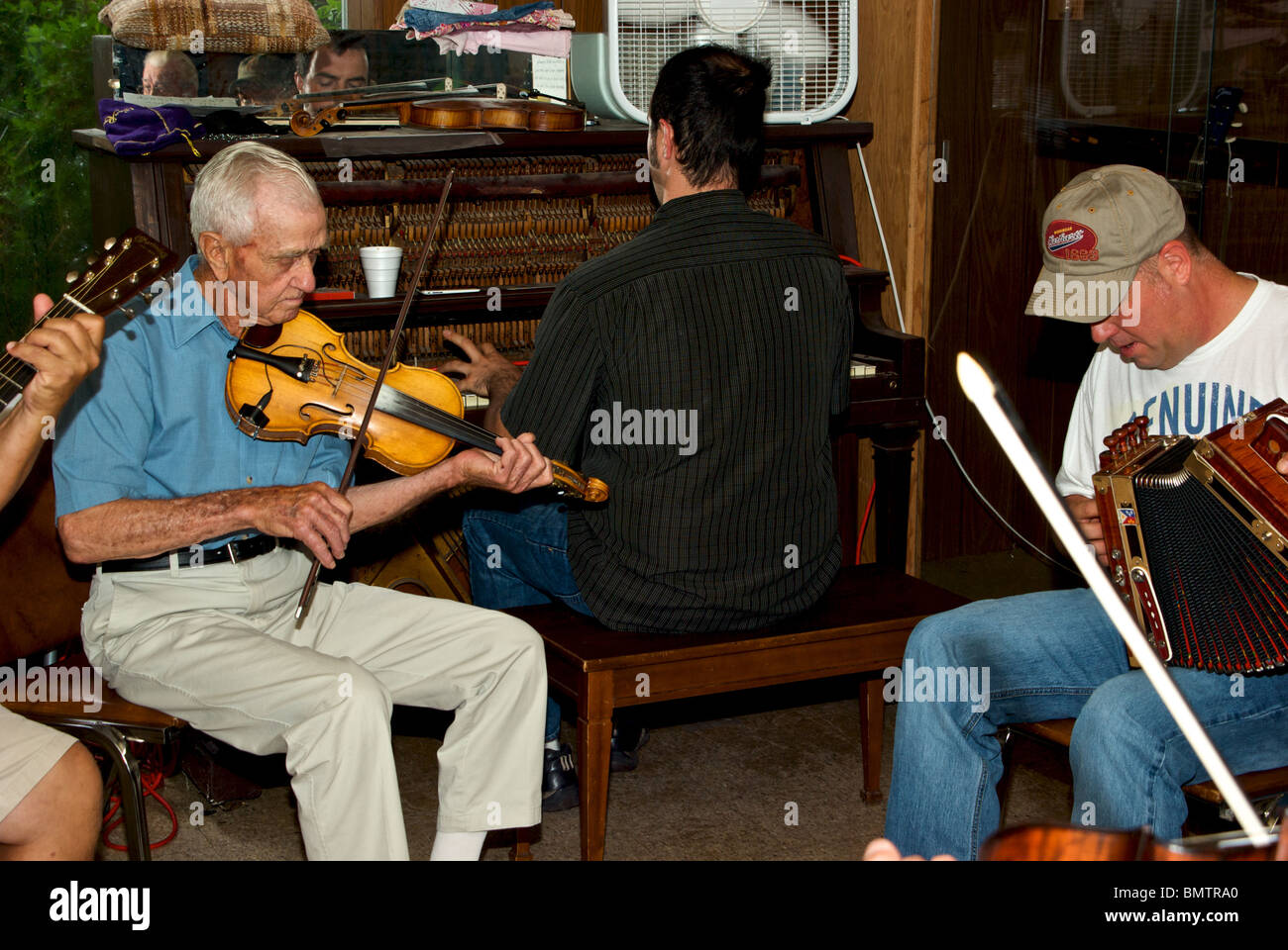 Musicians at crowded weekly Cajun music jam session held every Saturday ...