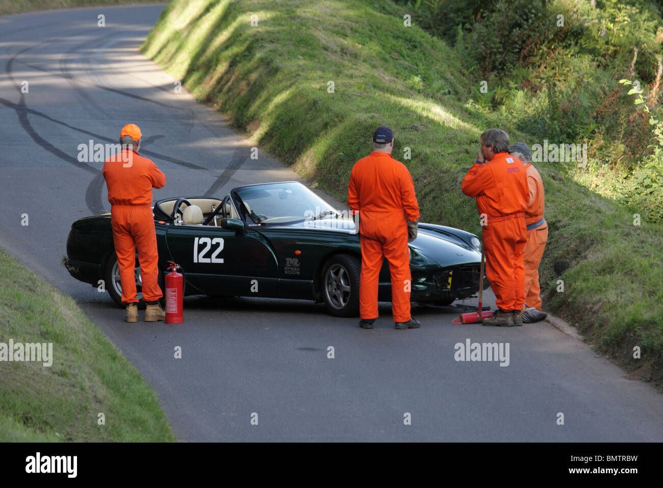 Marshals attending to a crashed TVR at Shelsley Walsh hill climb ...