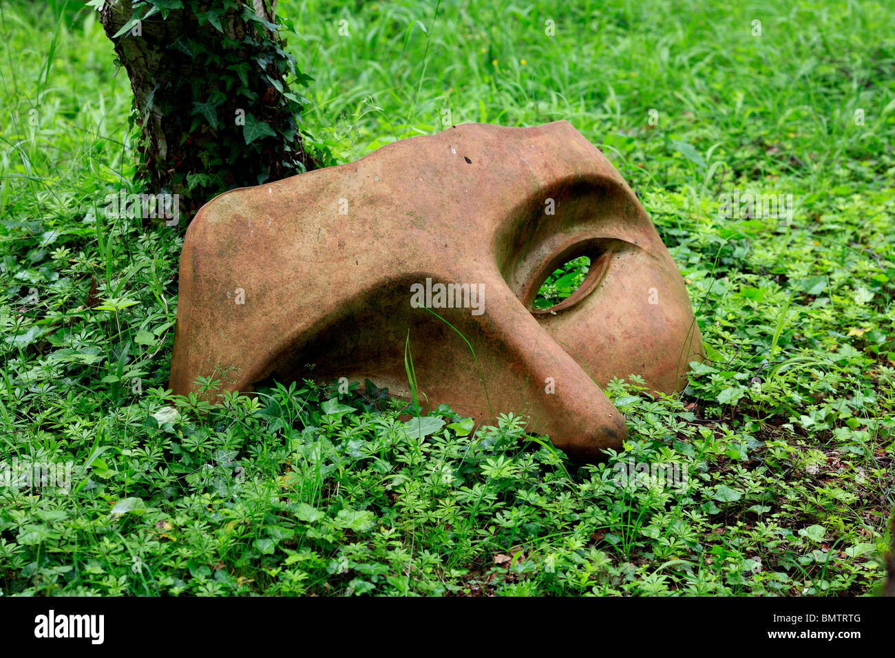 face mask garden statue Stock Photo - Alamy