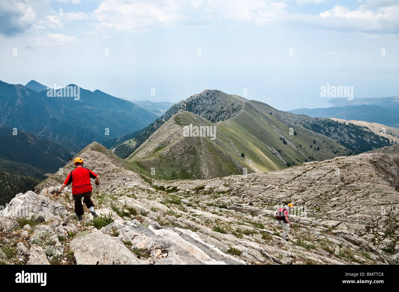 Walkers descending a ridge below the summit of Kokinovouni, Taygetos ...