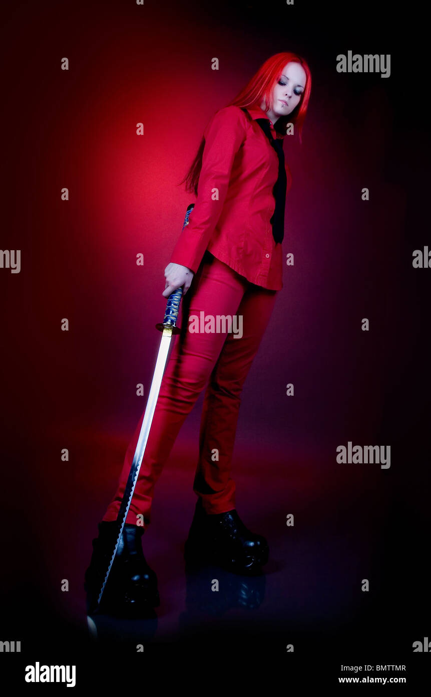Girl in a red suit with a Japanese sword. very sad Stock Photo - Alamy