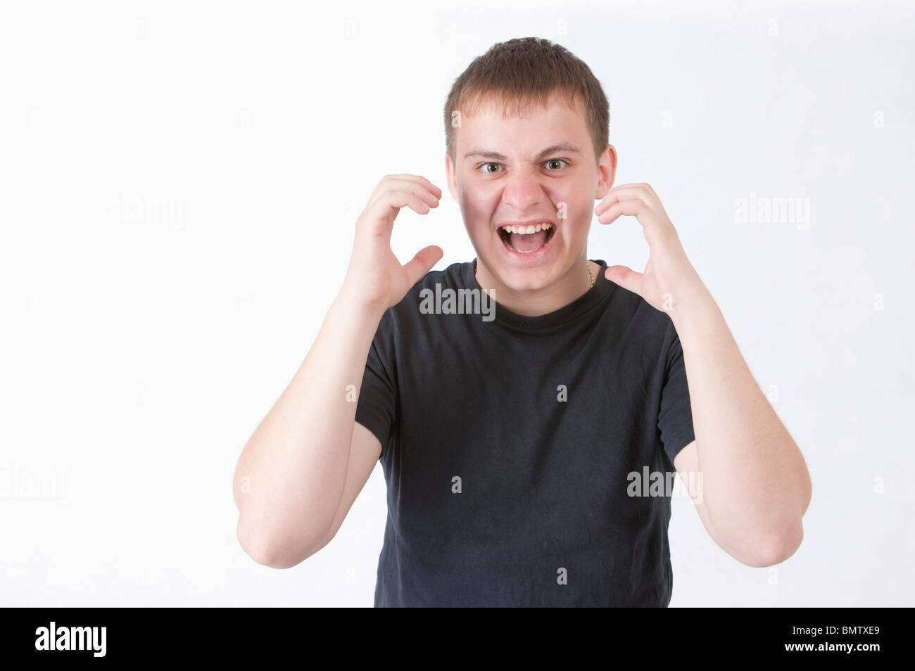 Close-up of young man screaming with mouth open Stock Photo - Alamy
