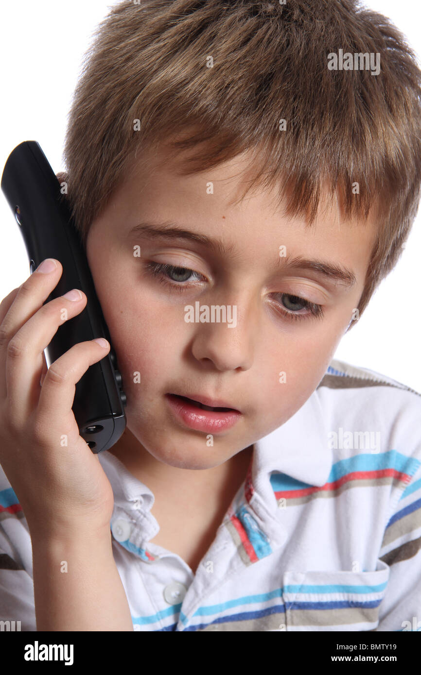 Small boy using a telephone talking to his friend Stock Photo - Alamy