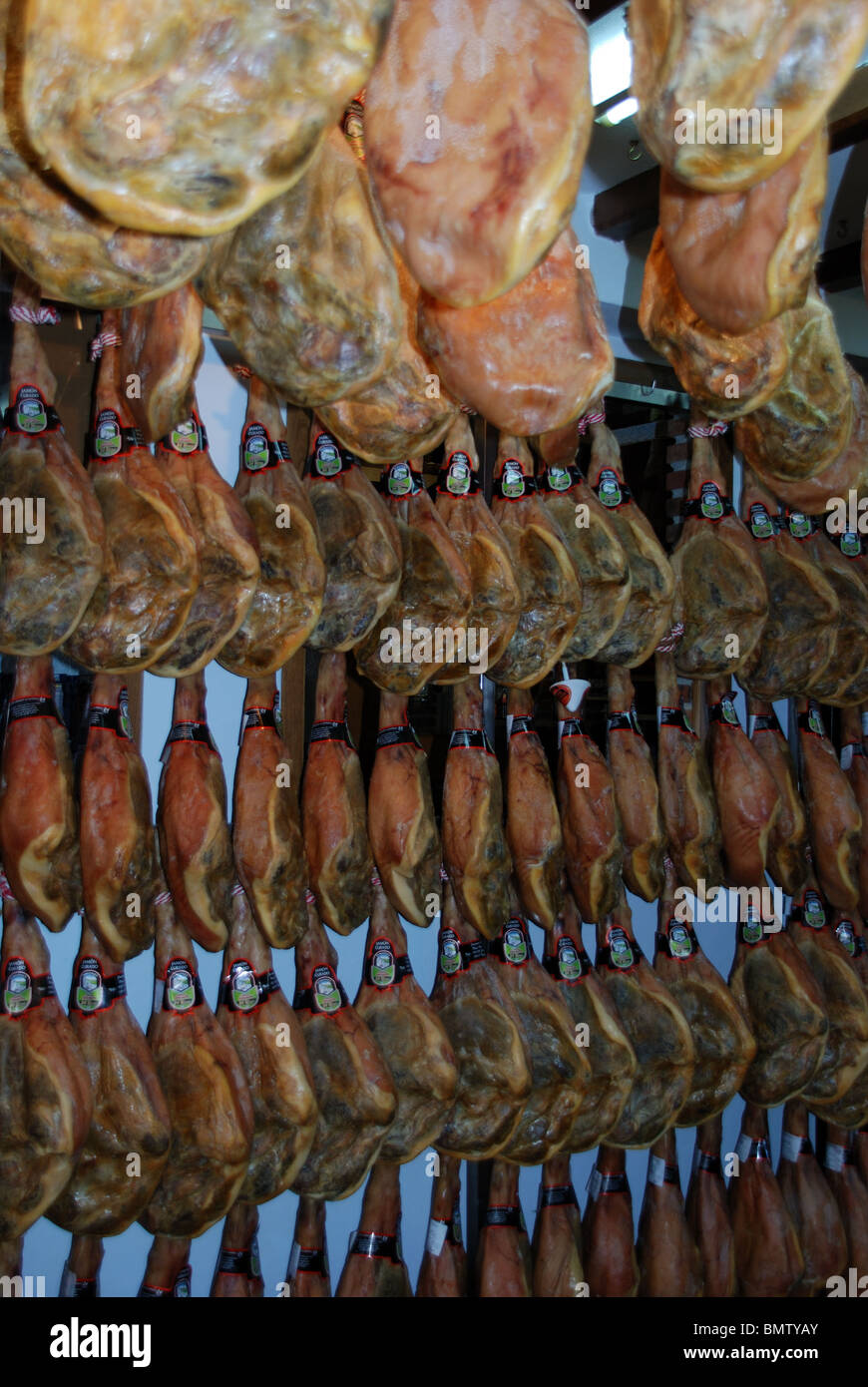 Cured legs of ham (Jamon Serrano) hanging in a shop, Trevelez, Las ...