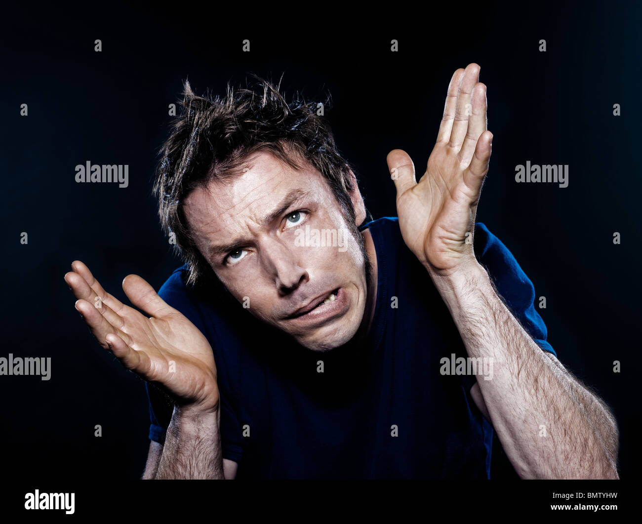 studio portrait on black background of a funny expressive caucasian man ...