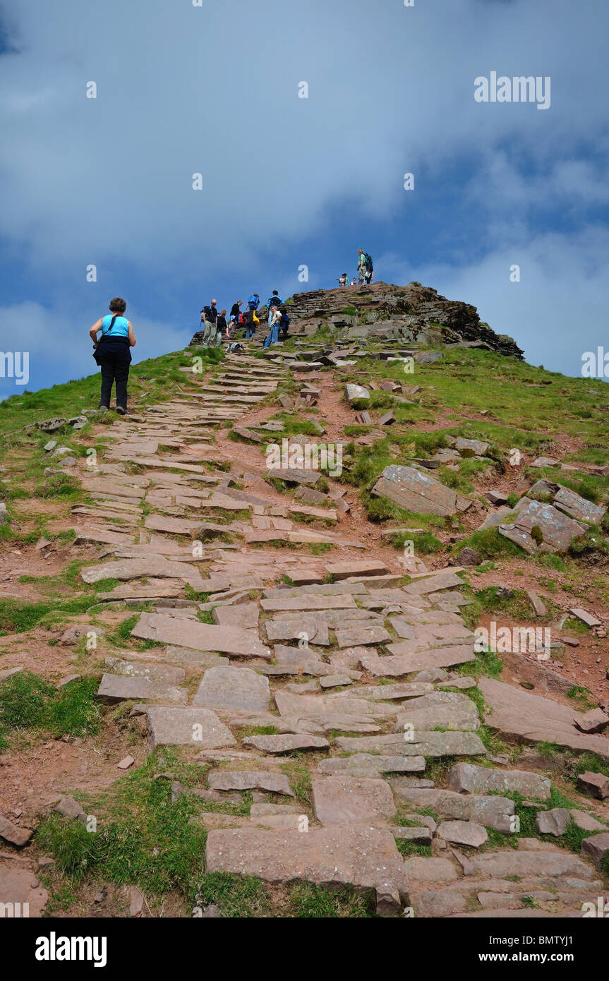 Walkers climb the paved pathway up to the summit of Corn Du in the ...