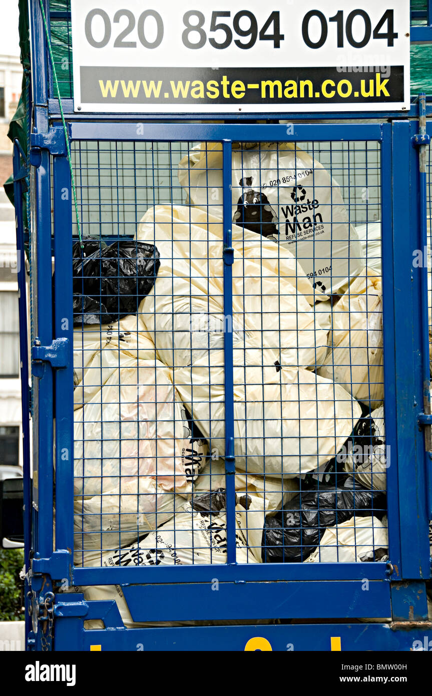 a private waste collection truck in london full with white bags Stock ...
