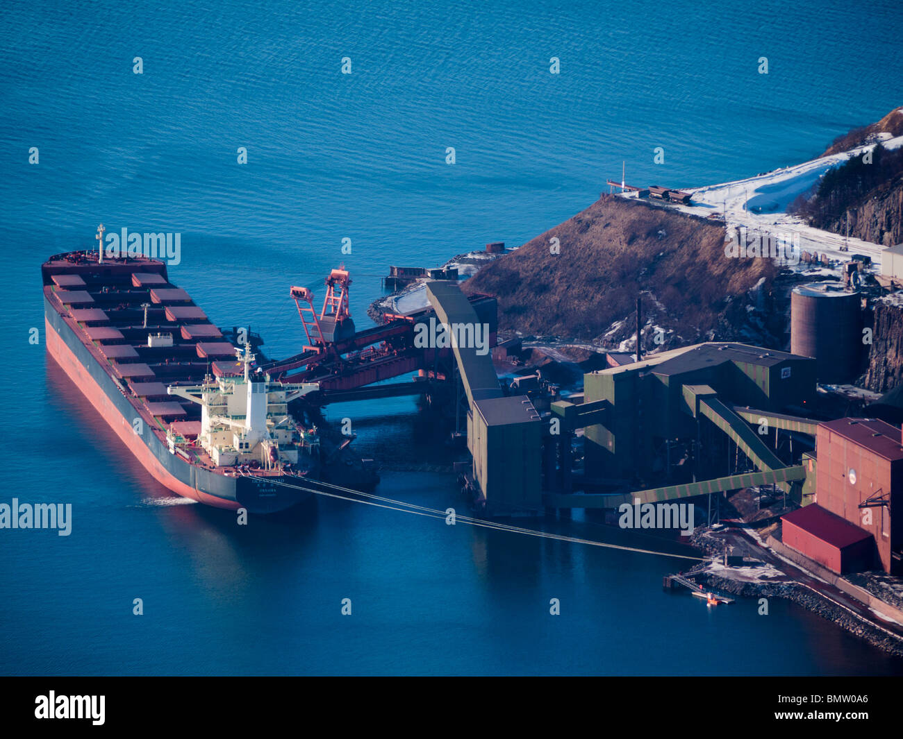 In the port of Narvik at the Ofotfjord a freighter is being loaded with ...