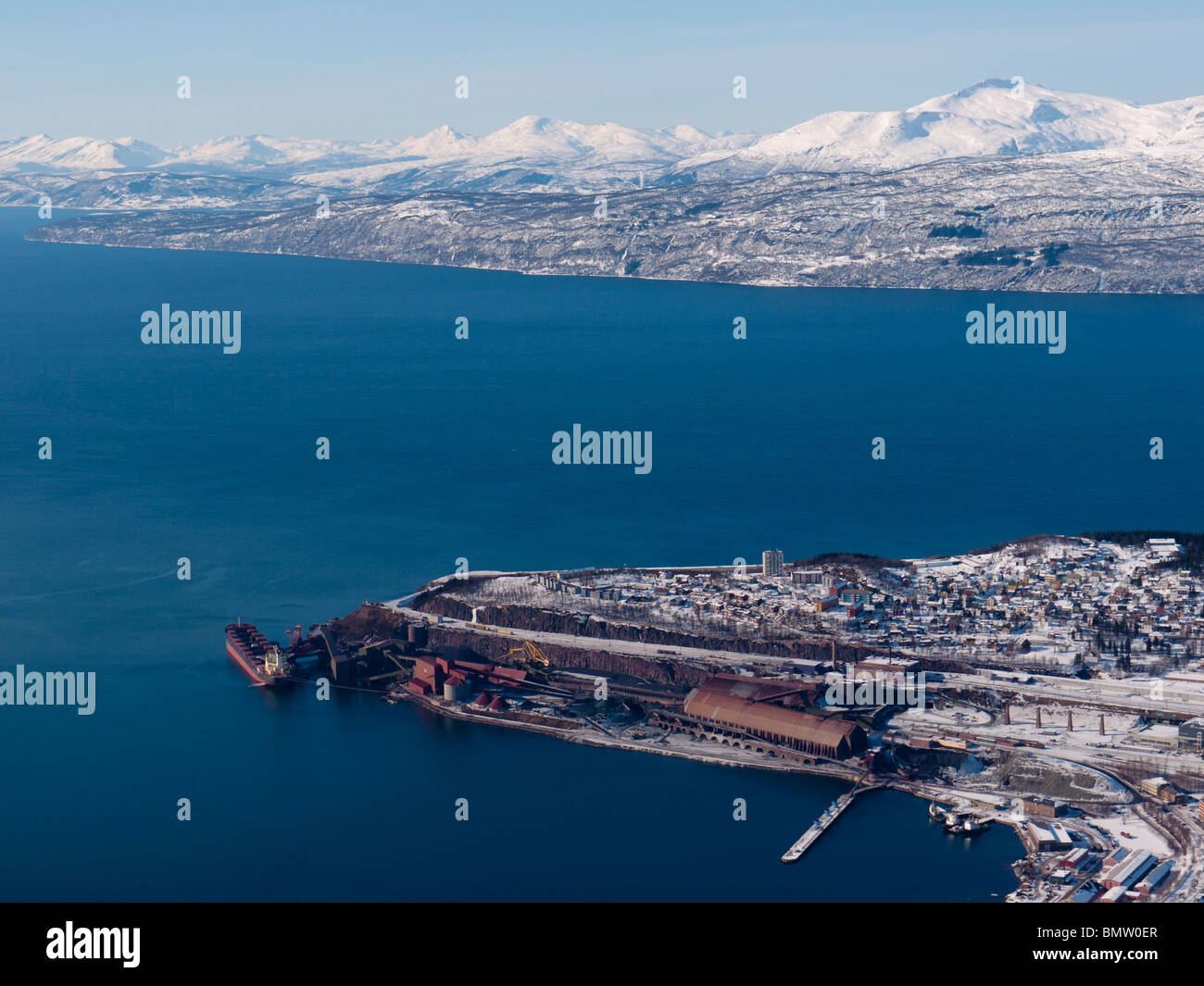 In the port of Narvik at the Ofotfjord a freighter is being loaded with ...