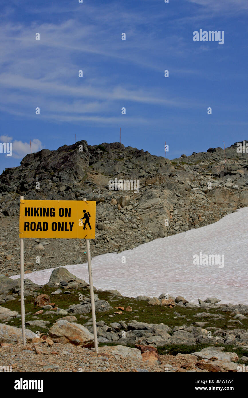 Hiking on road sign Stock Photo - Alamy