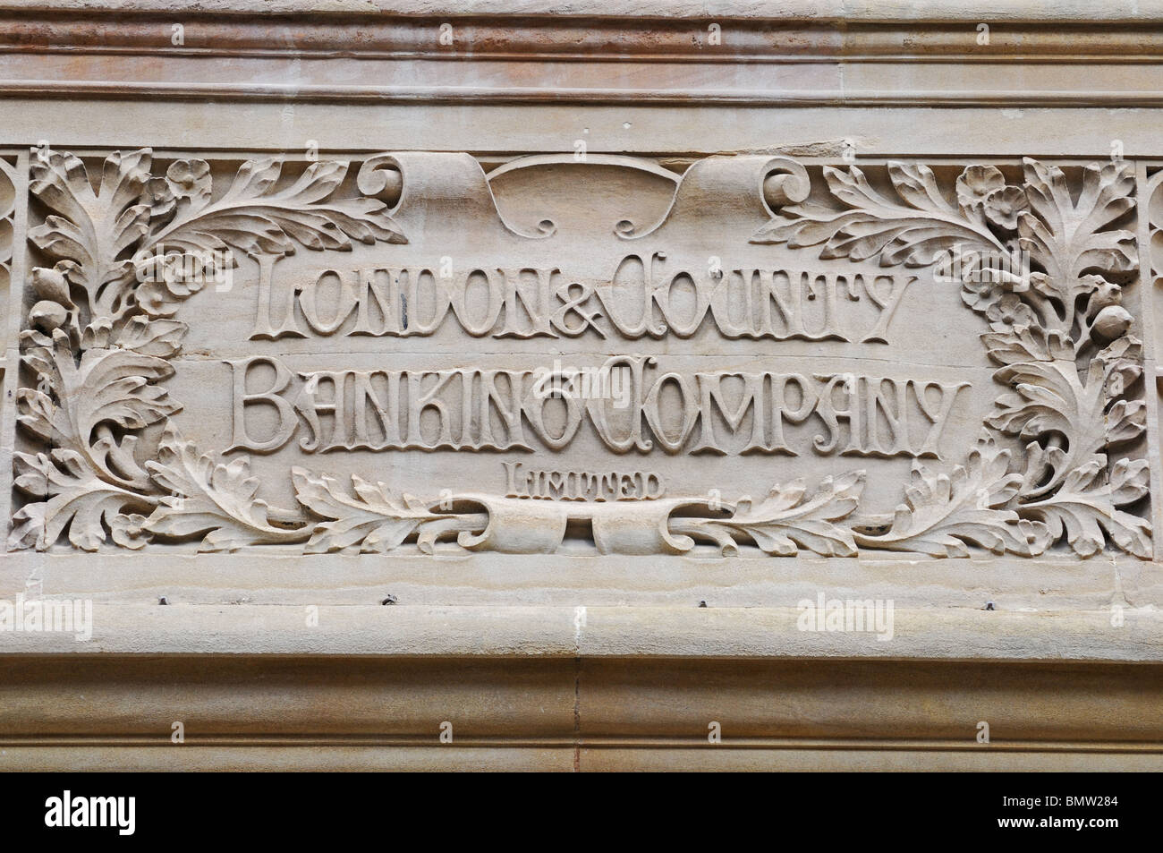 Decorated panel denoting old bank name under the window of present ...