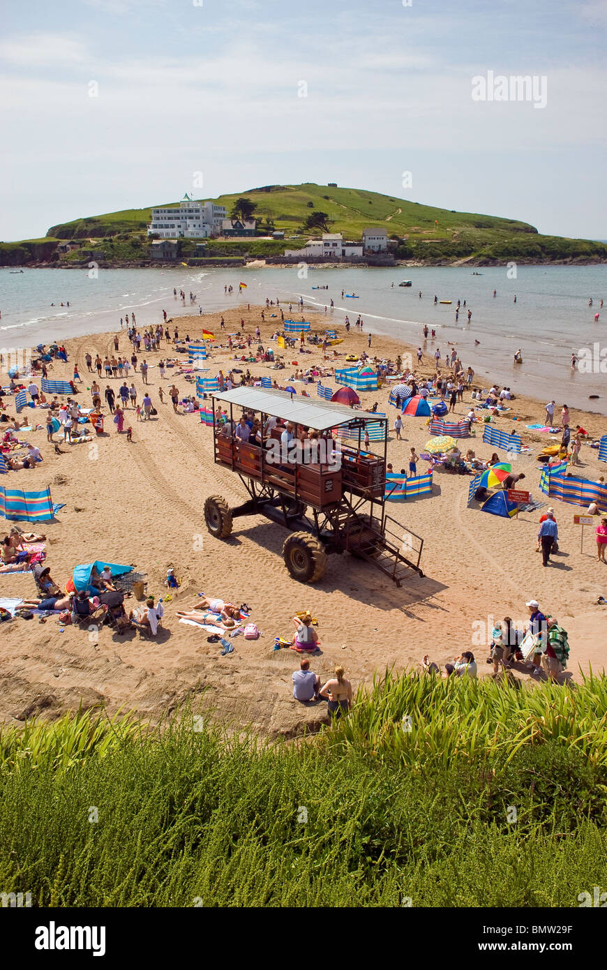 Holiday makers and the Burgh Island sea tractor on the beach at Bigbury ...