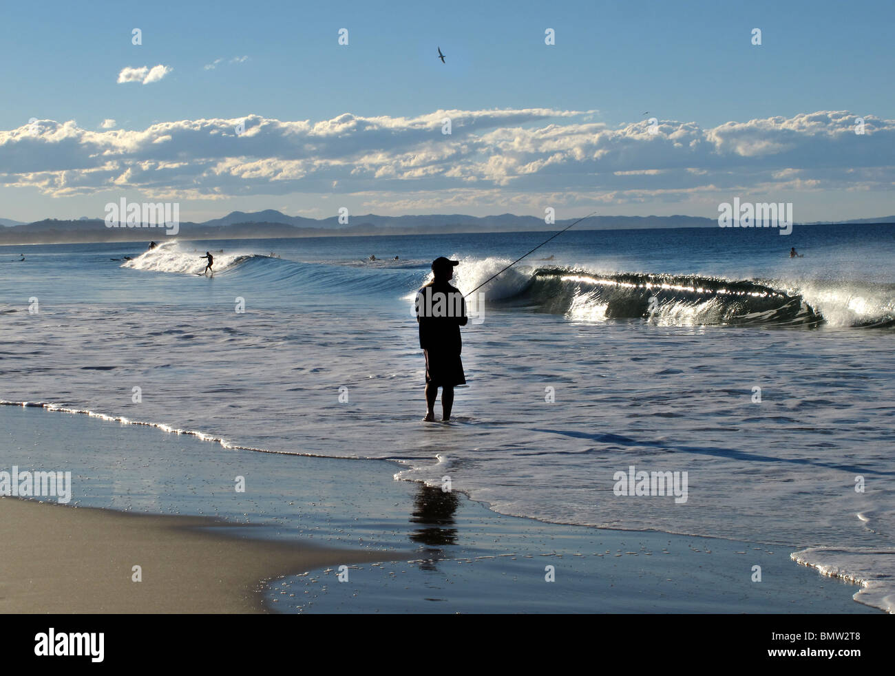 Fishing and surfing at Belongil Byron Bay Stock Photo - Alamy