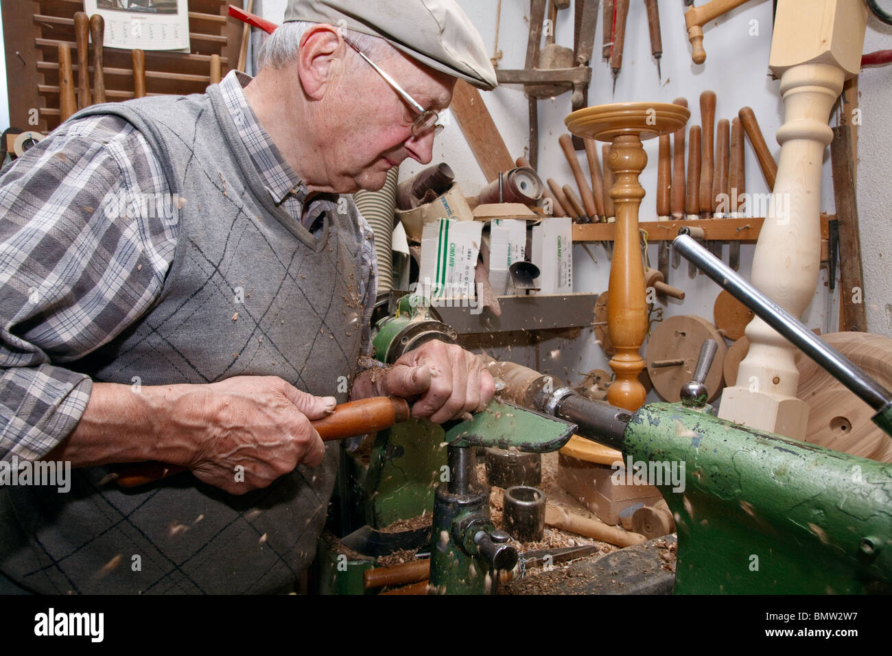 Master Woodturning man working on lathe with chisel turning and ...