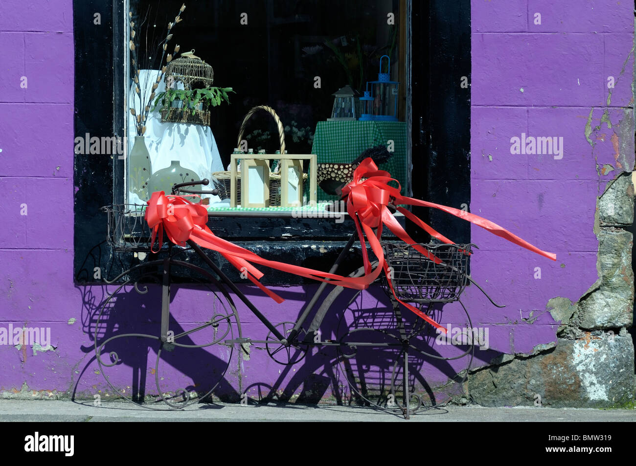 An old ornamental bicycle outside a shop window Stock Photo - Alamy