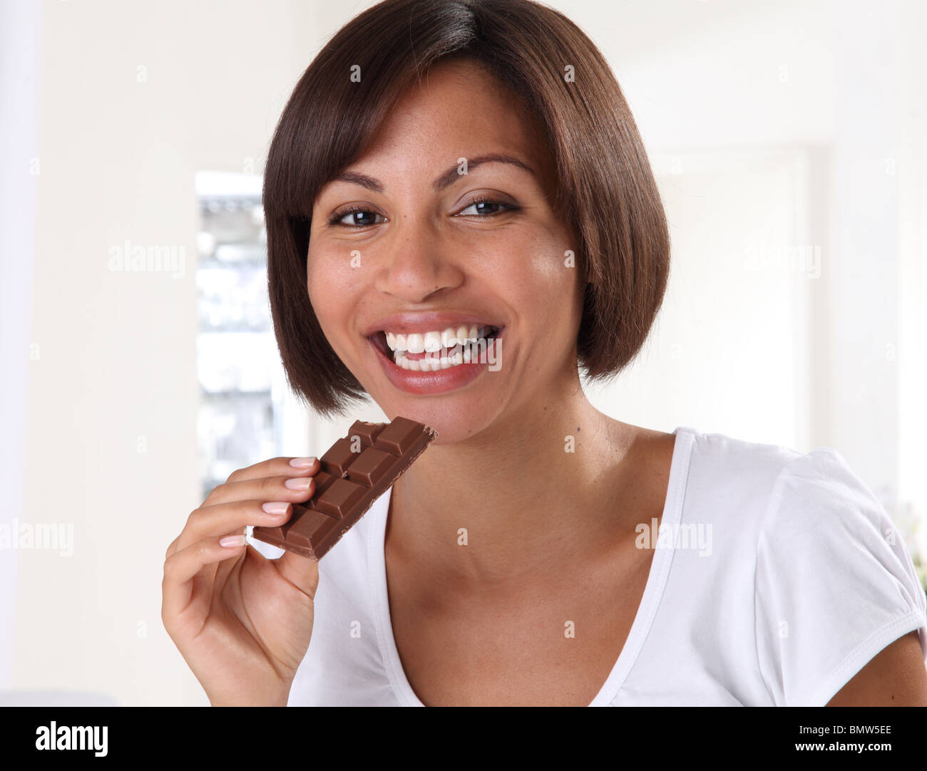 WOMAN EATING CHOCOLATE Stock Photo - Alamy