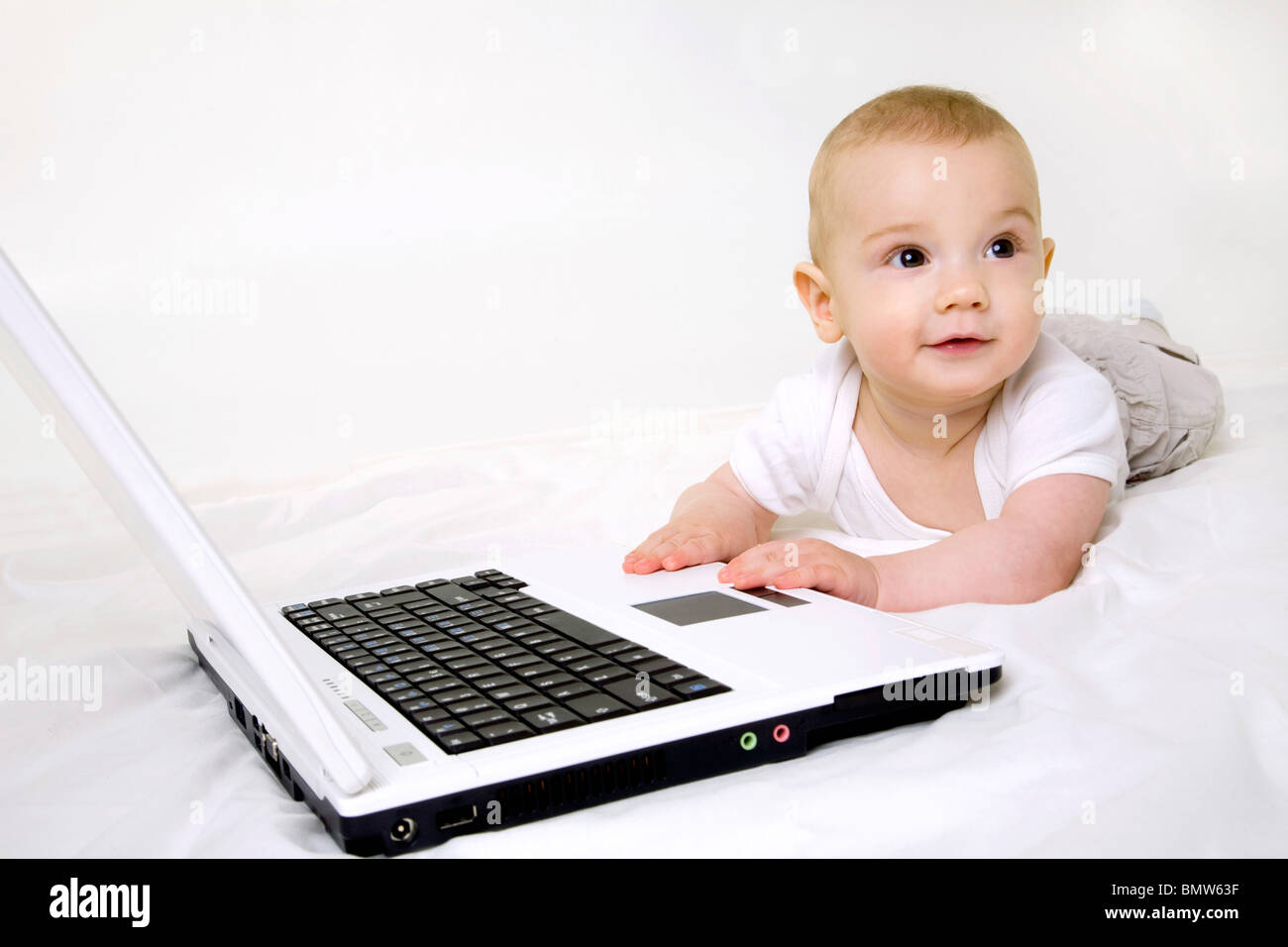 adorable baby with laptop on white background Stock Photo - Alamy