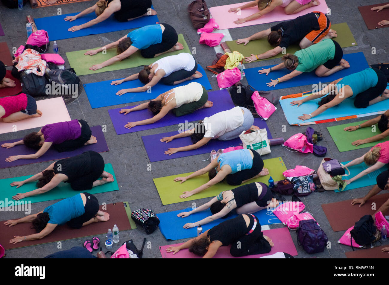 Yoga practitioners in Times Square in NY participate in one of the free ...