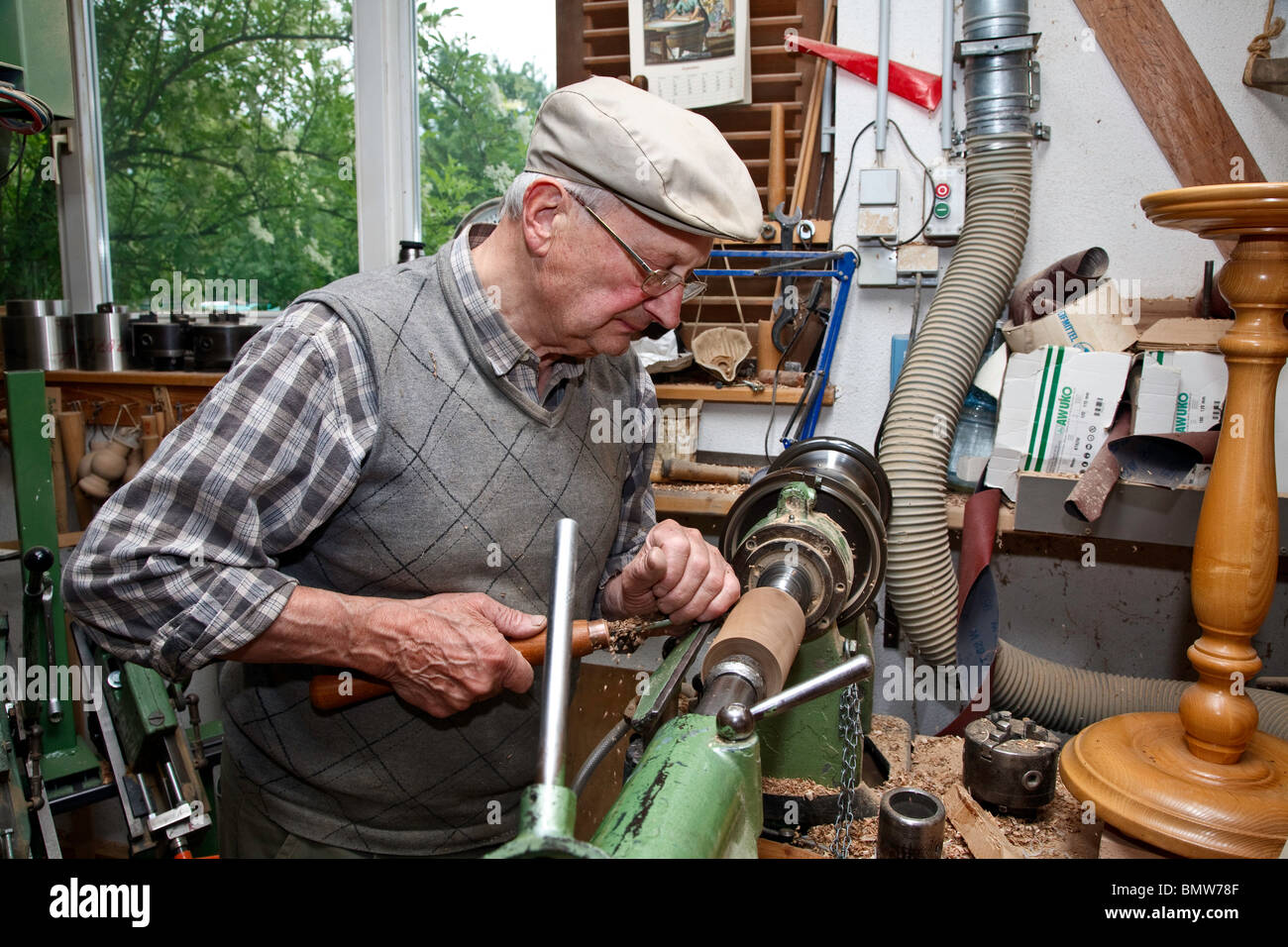 Master Woodturning man working on lathe with chisel turning and ...