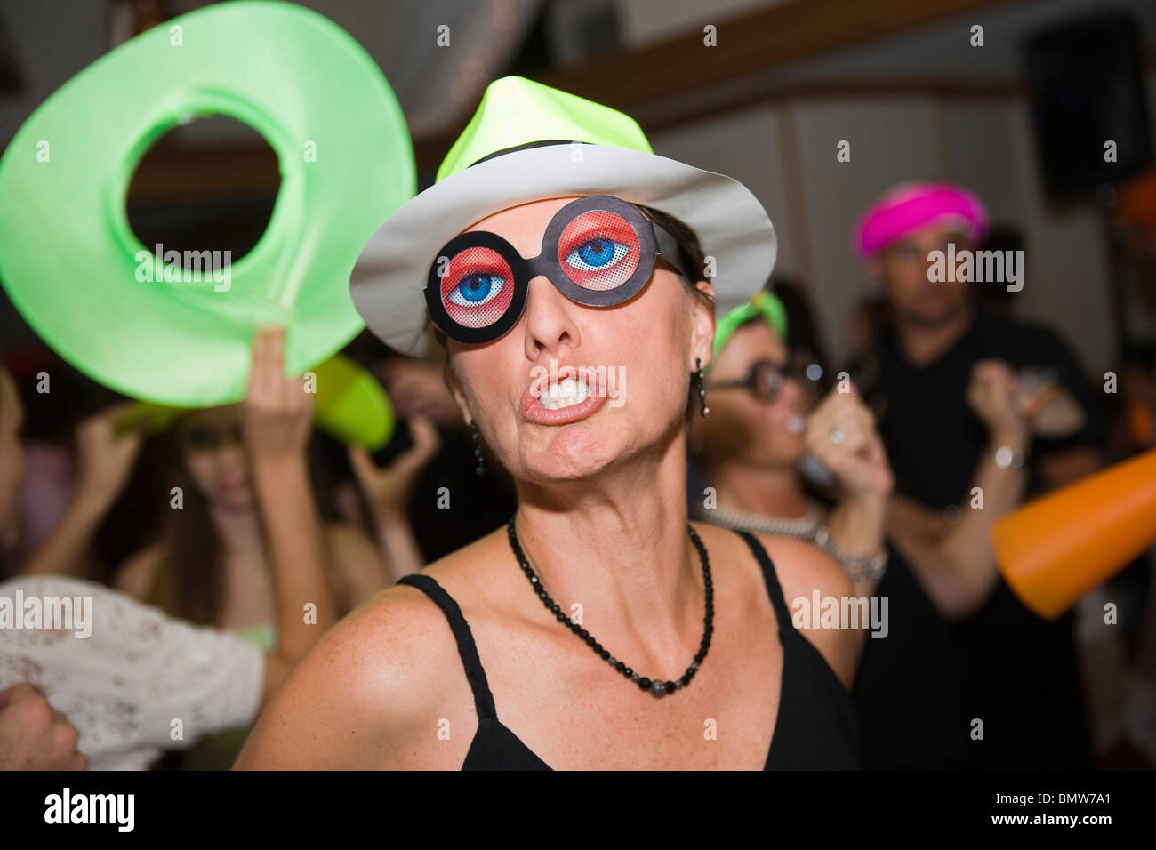 Woman with funny glasses and hat in a party Stock Photo - Alamy