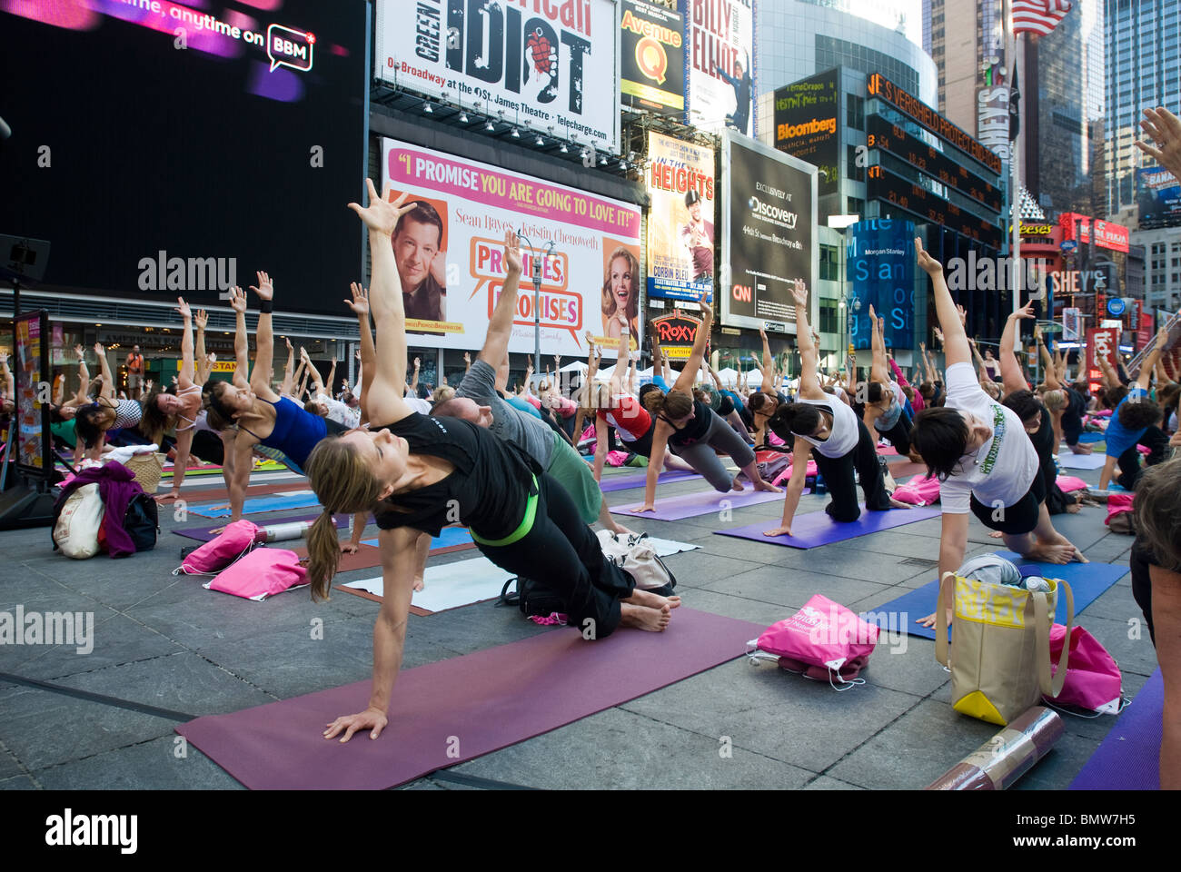 Yoga practitioners in Times Square in NY participate in one of the free ...