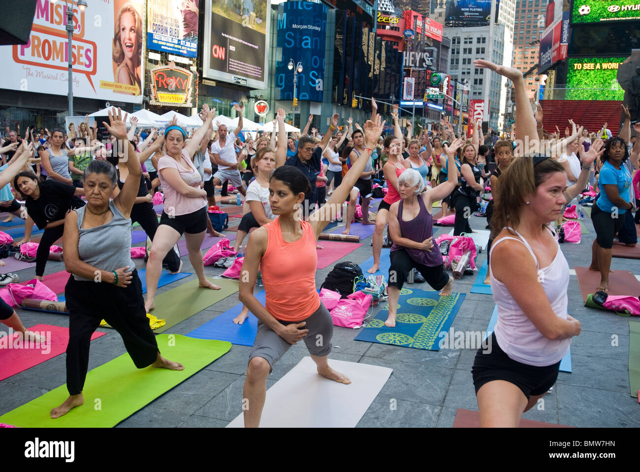 Yoga practitioners in Times Square in NY participate in one of the free ...