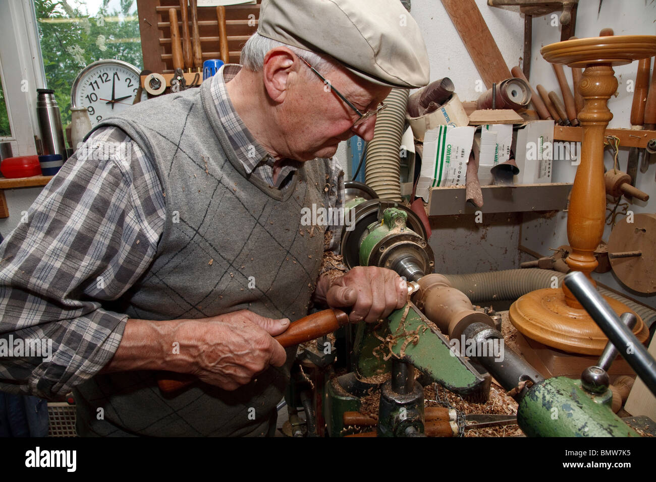 Master Woodturning man working on lathe with chisel turning and ...