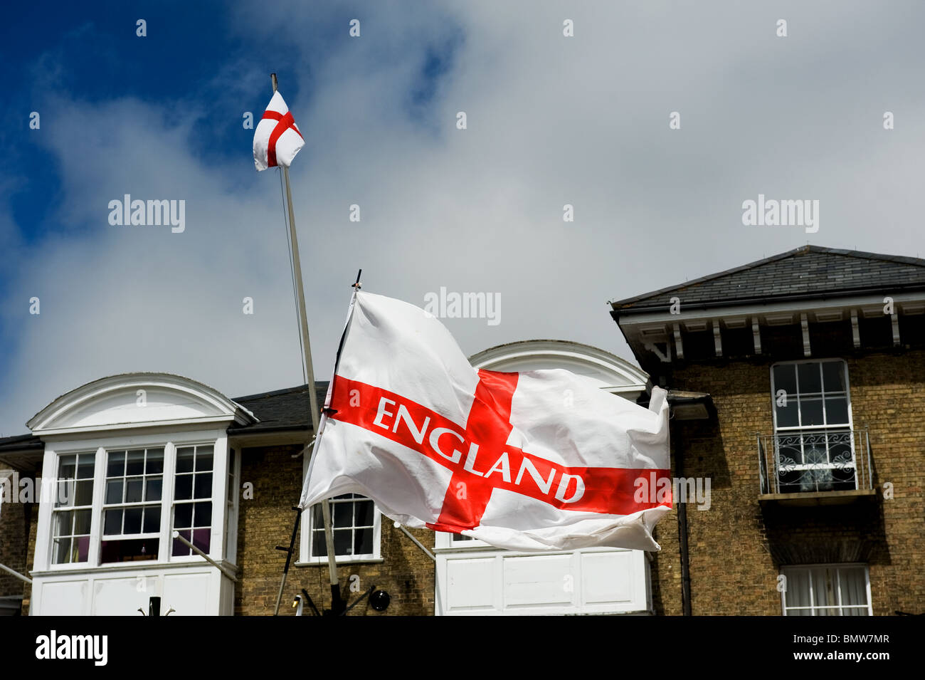 A large England flag in front of buildings Stock Photo - Alamy