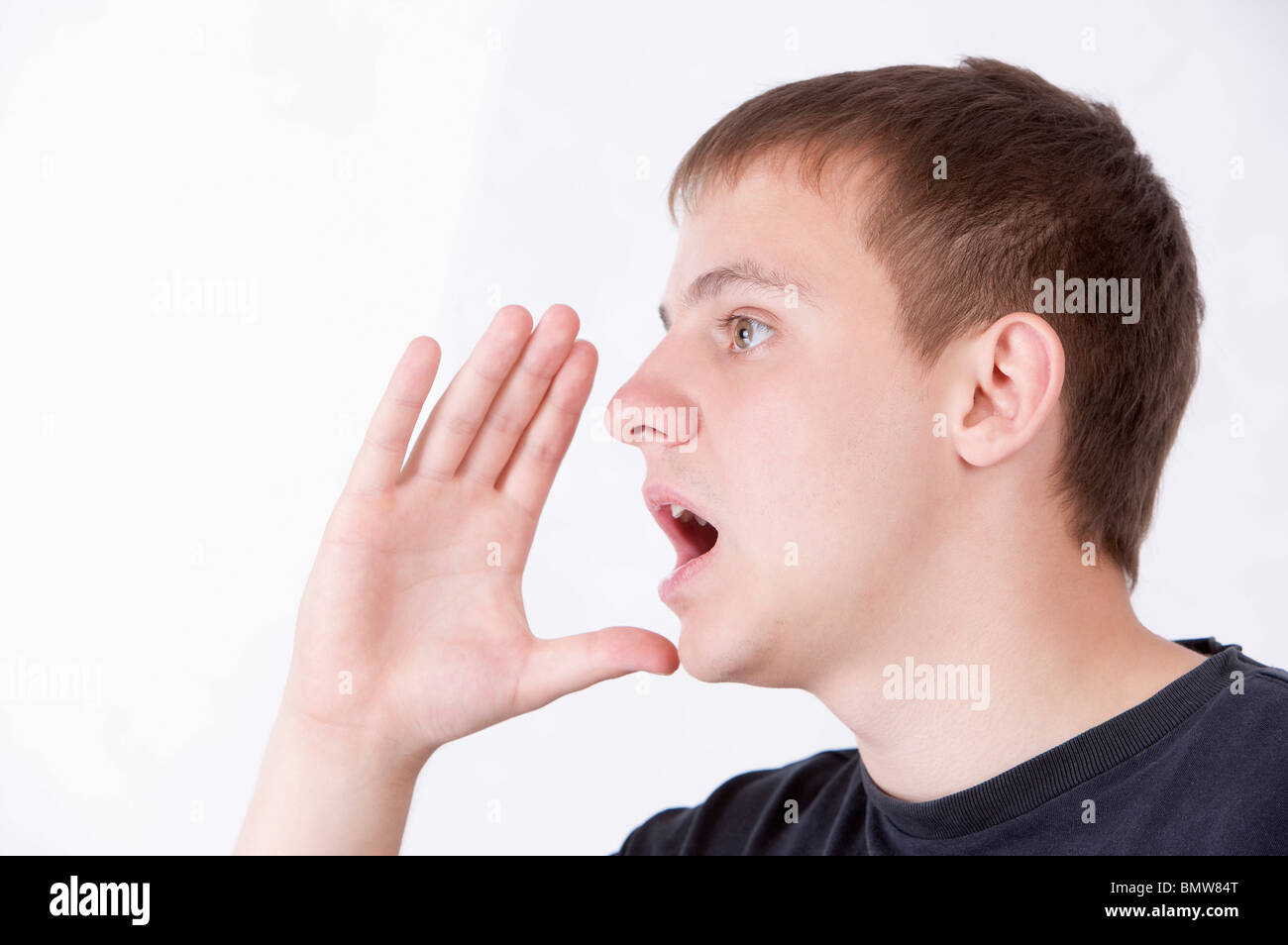 Close-up of young man shouting and looking away Stock Photo - Alamy
