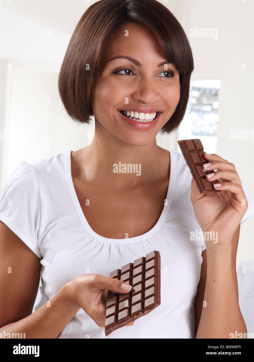 WOMAN EATING CHOCOLATE Stock Photo - Alamy
