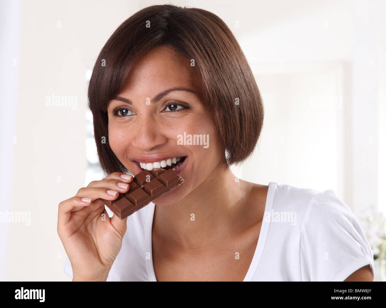 WOMAN EATING CHOCOLATE Stock Photo - Alamy