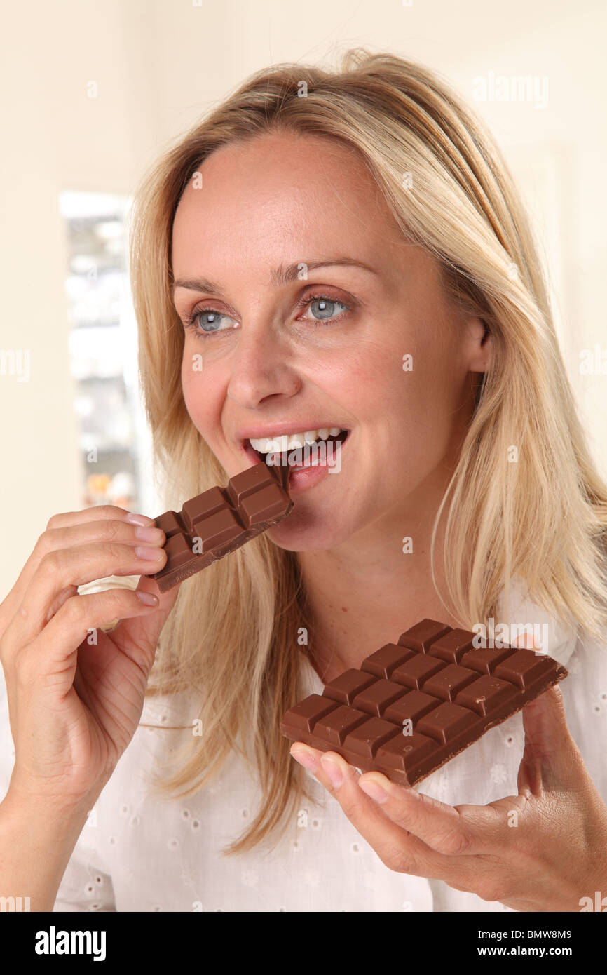 WOMAN EATING CHOCOLATE Stock Photo - Alamy