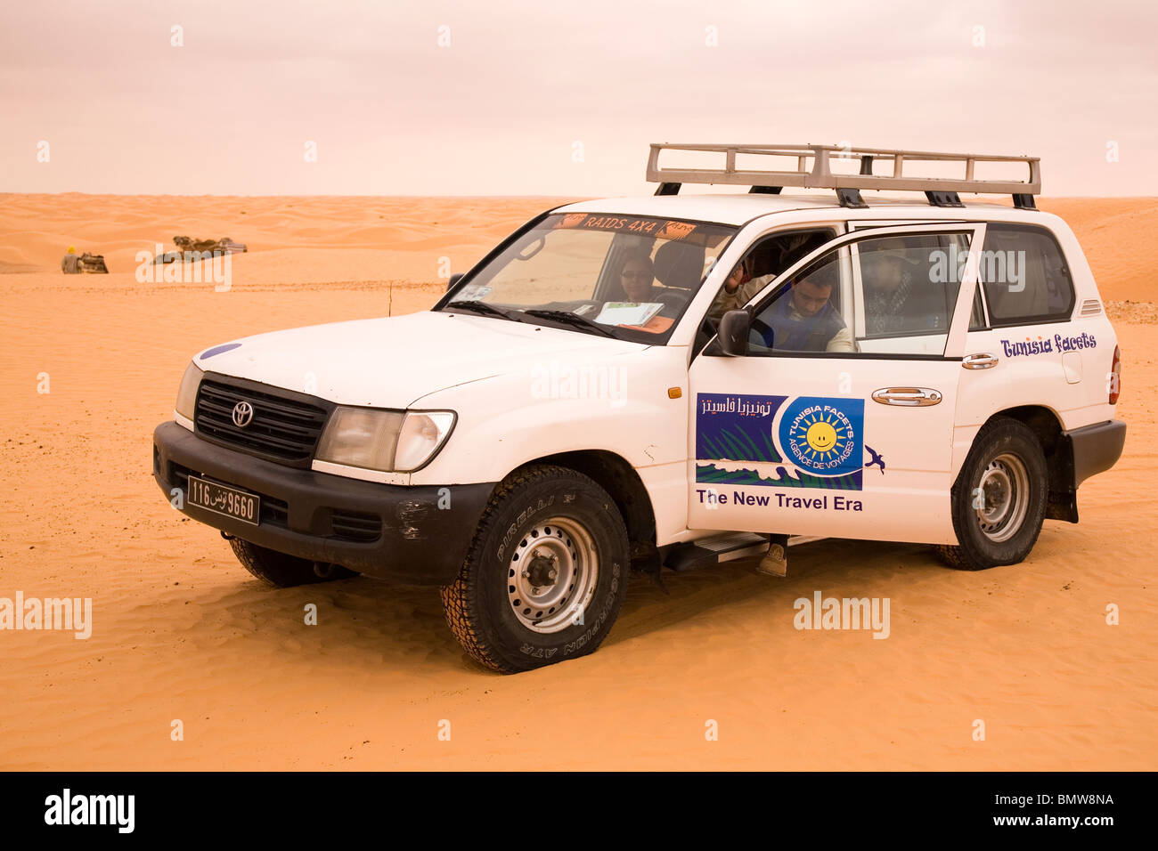 A four wheel drive vehicle transports tourists in the Sahara Desert in ...