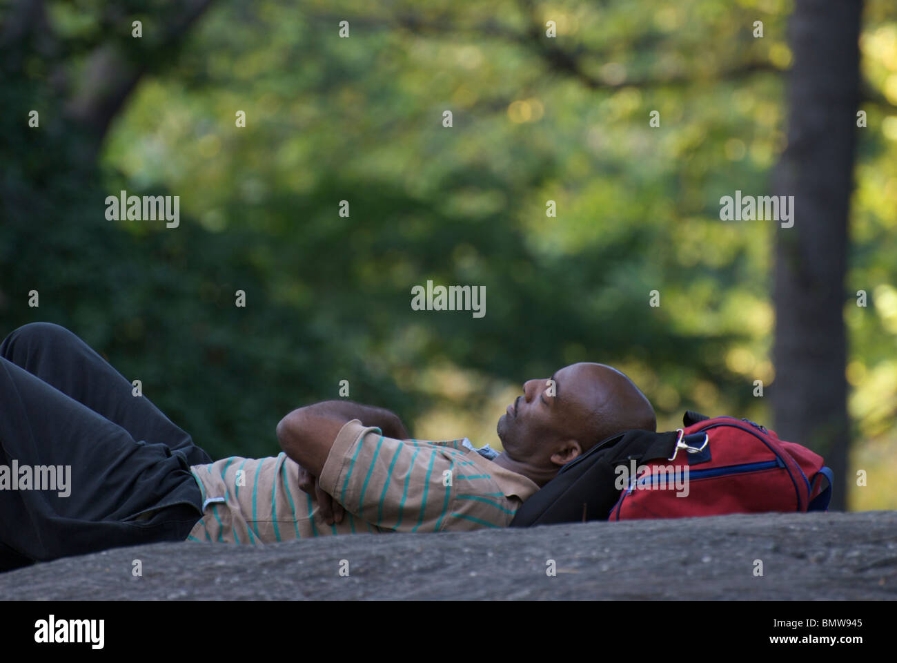 A man laying down in Central Park, New York Stock Photo - Alamy