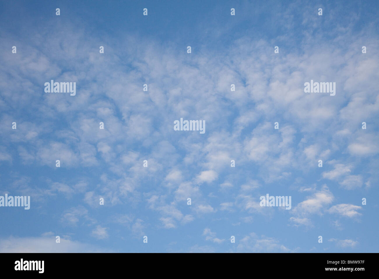 Wispy white clouds make patterns against a blue sky in a late summer ...