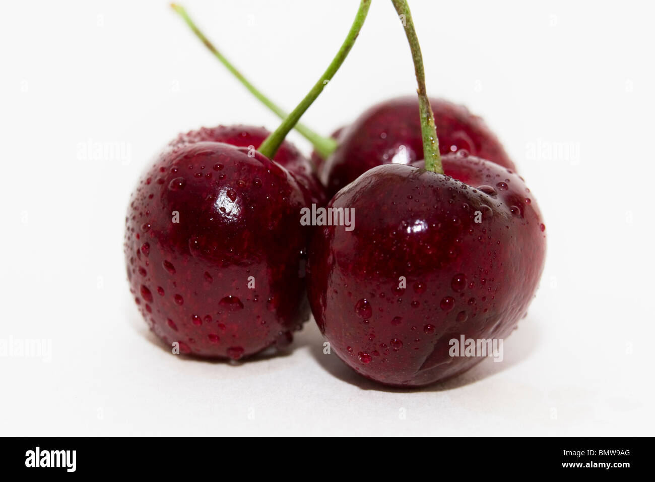 Three sweet cherries isolated on white background Stock Photo - Alamy