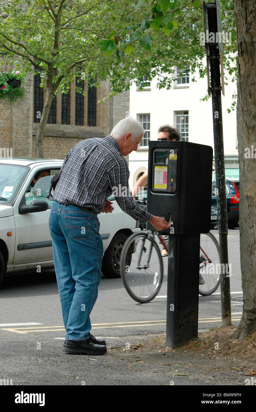 Man at a parking meter Stock Photo - Alamy