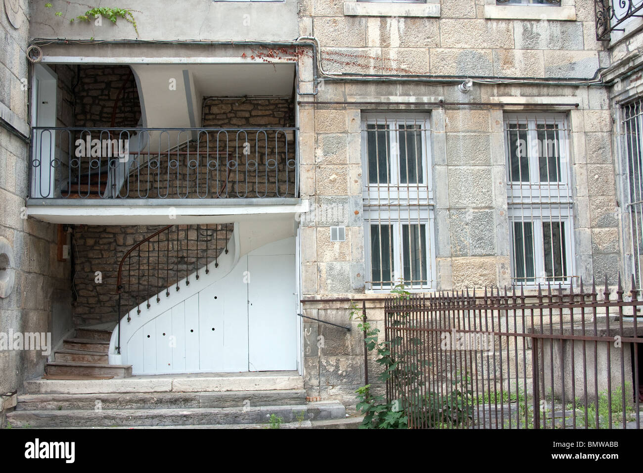 courtyard open stairs barred windows flats fence Stock Photo - Alamy
