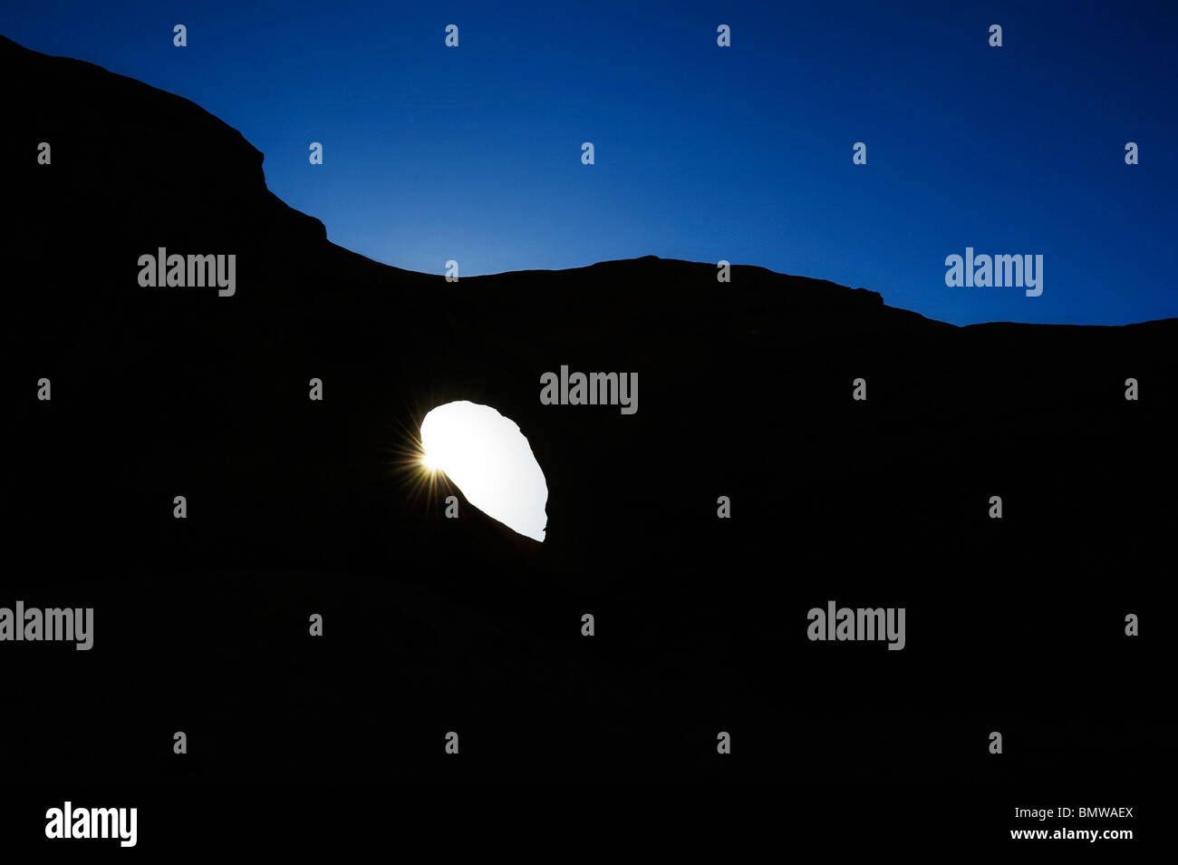 Ear of the Wind rock formation and setting sun Monument Valley Arizona ...